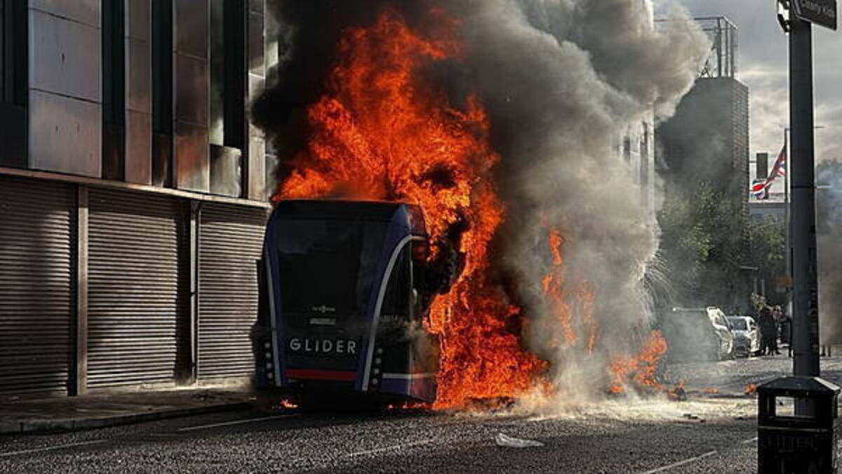 Bus set alight by masked protesters as violence flares following ...